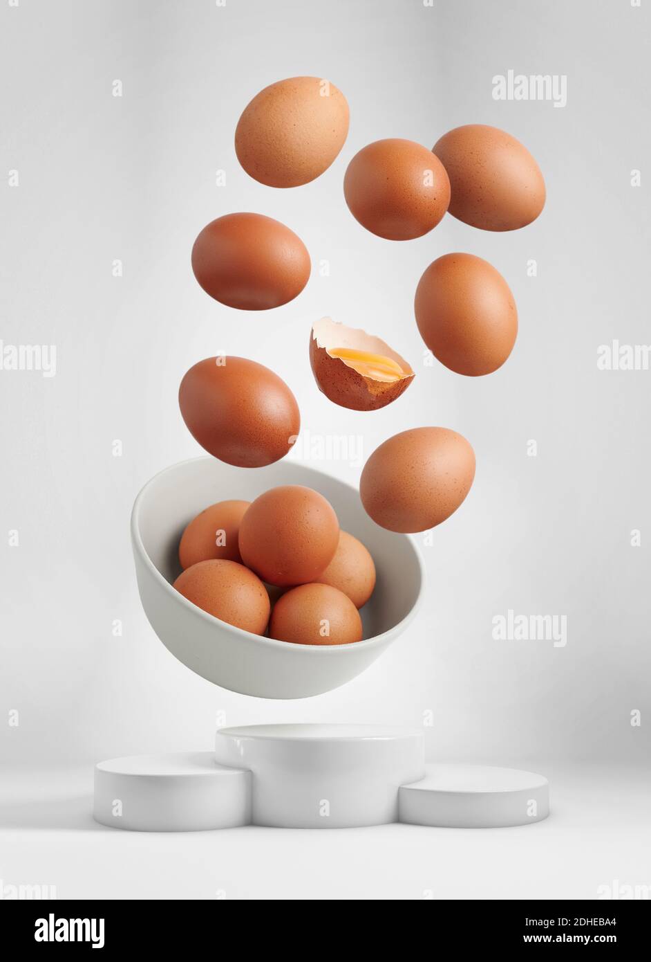 Fresh eggs flying over a winning podium Stock Photo - Alamy