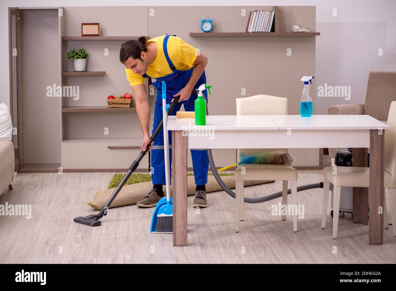 Young male contractor cleaning the house Stock Photo - Alamy