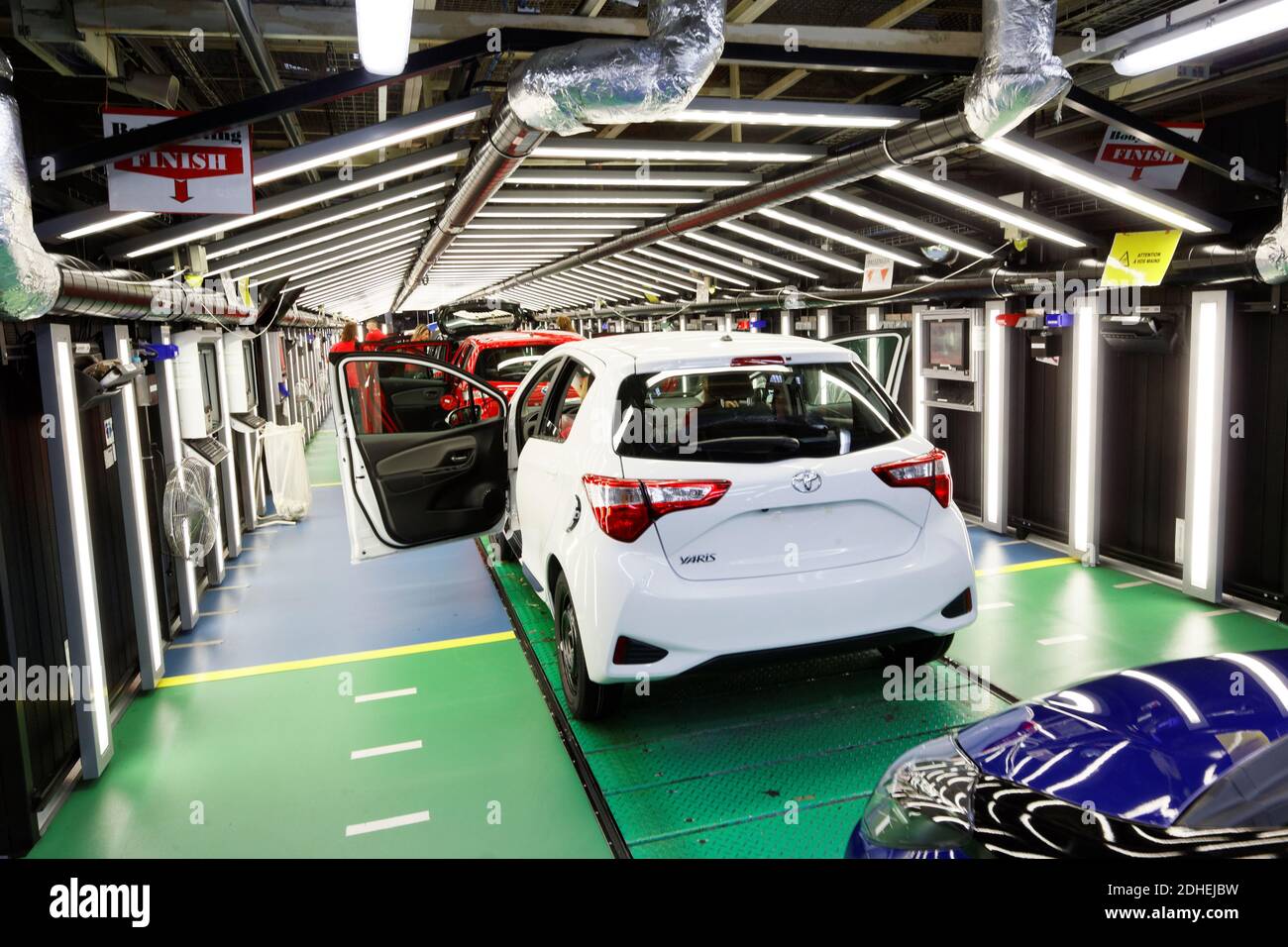 Toyota workers assemble Yaris and Yaris Hybrid cars on the company's ...