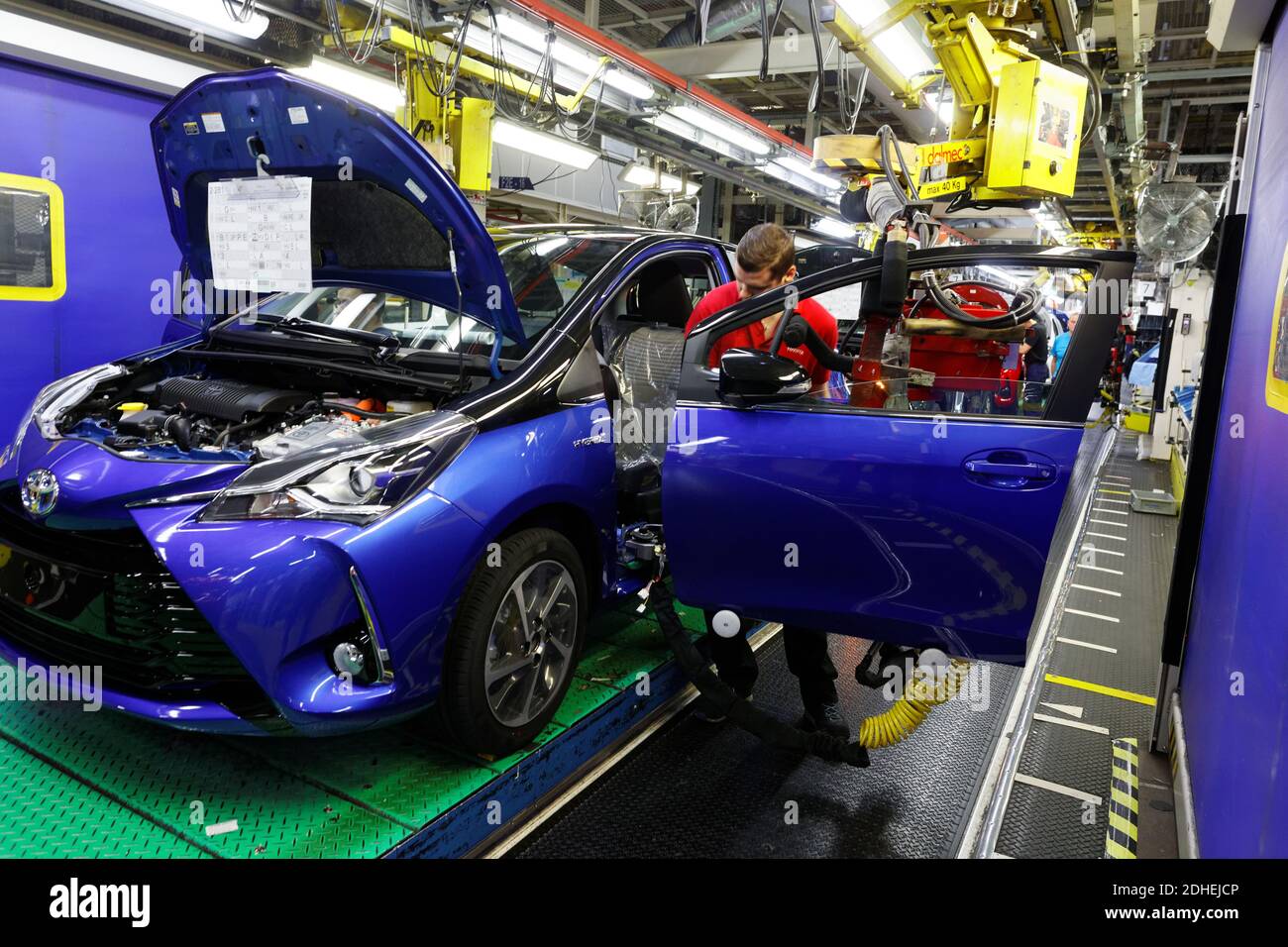Toyota workers assemble Yaris and Yaris Hybrid cars on the company's ...