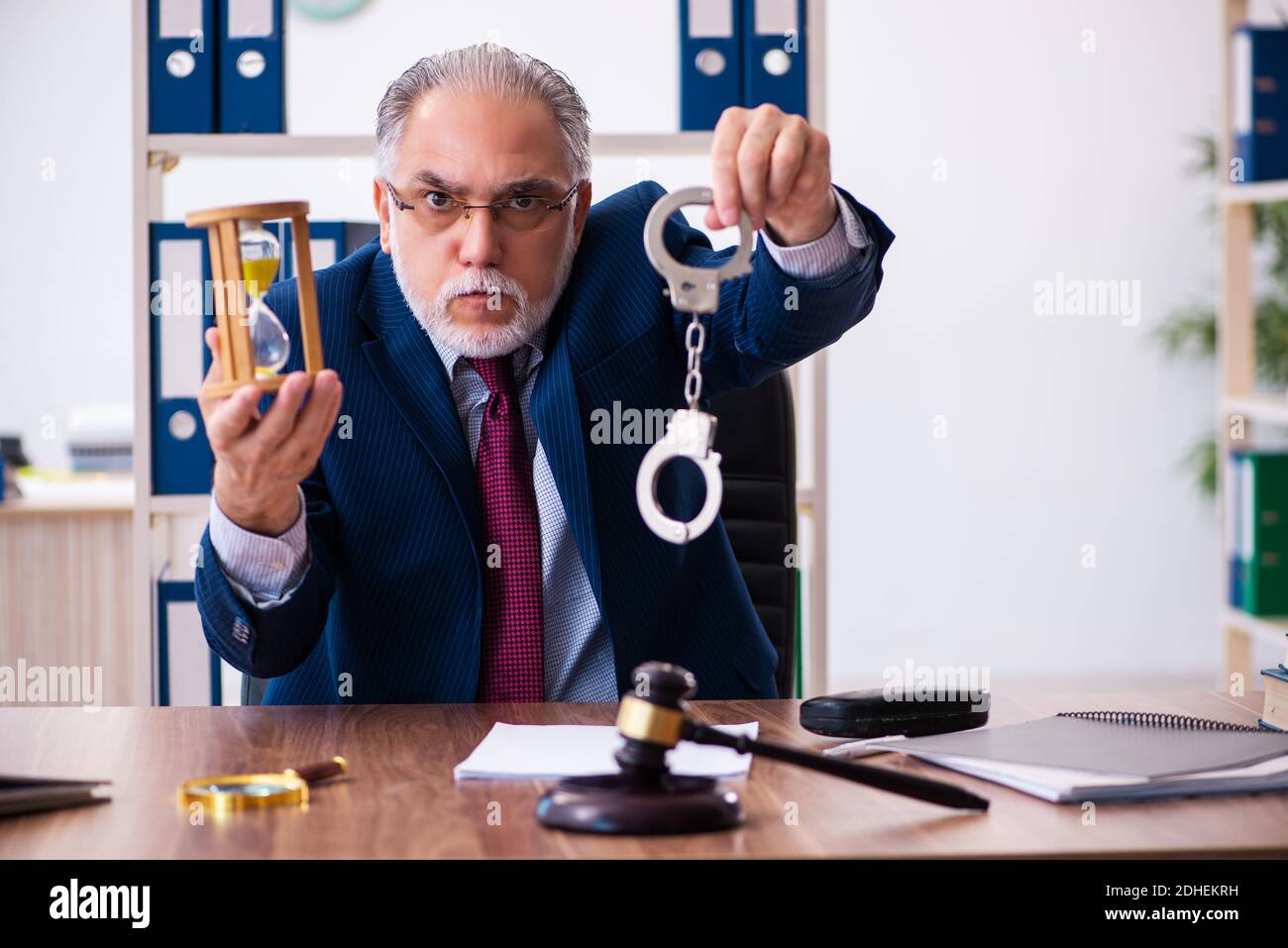 Experienced male judge sitting in the office Stock Photo - Alamy