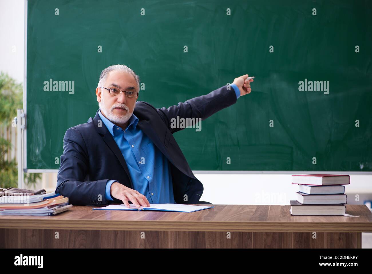 Primary teacher pointing to board hi-res stock photography and images ...