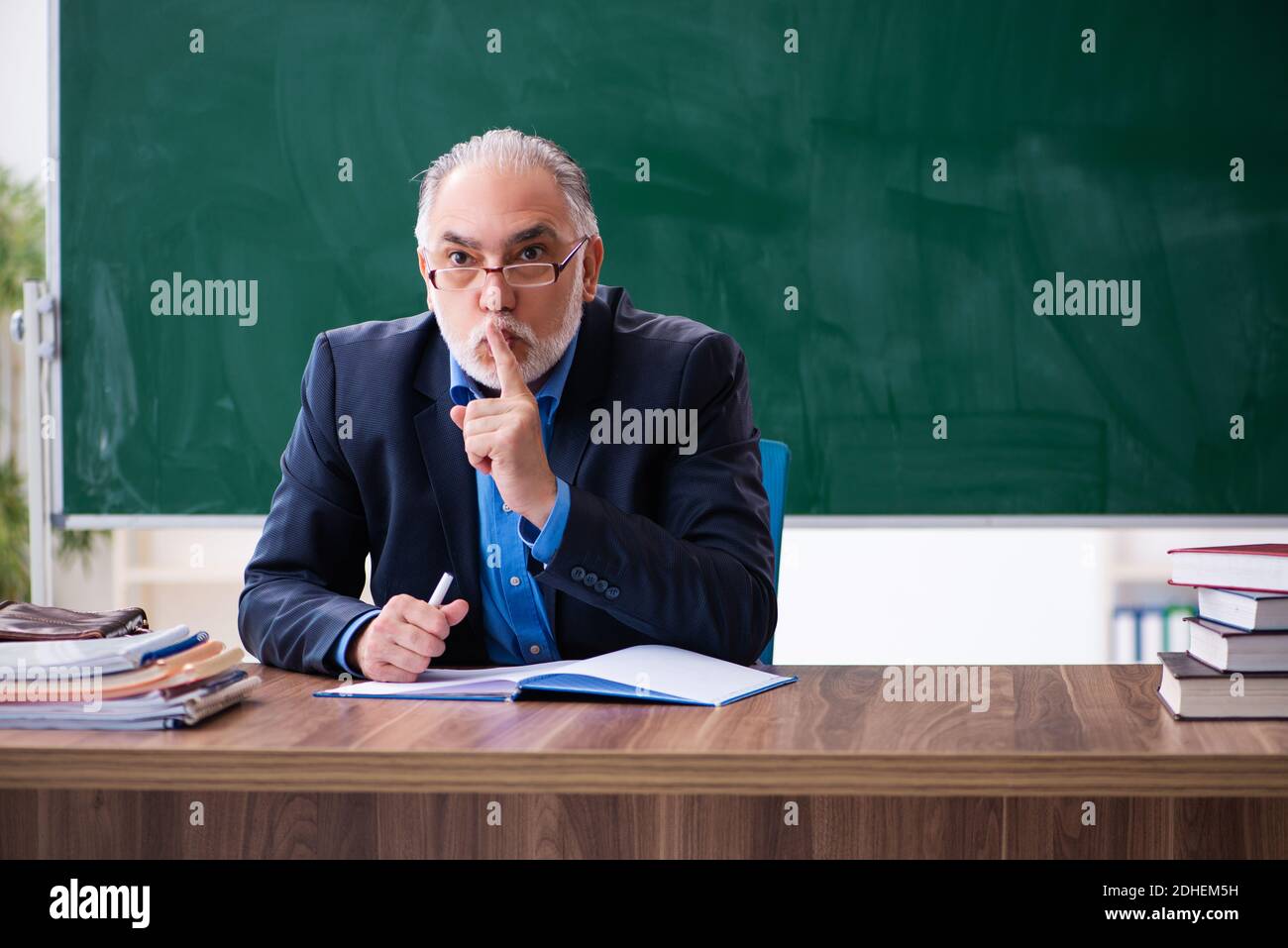 Old male math teacher in the classroom Stock Photo - Alamy
