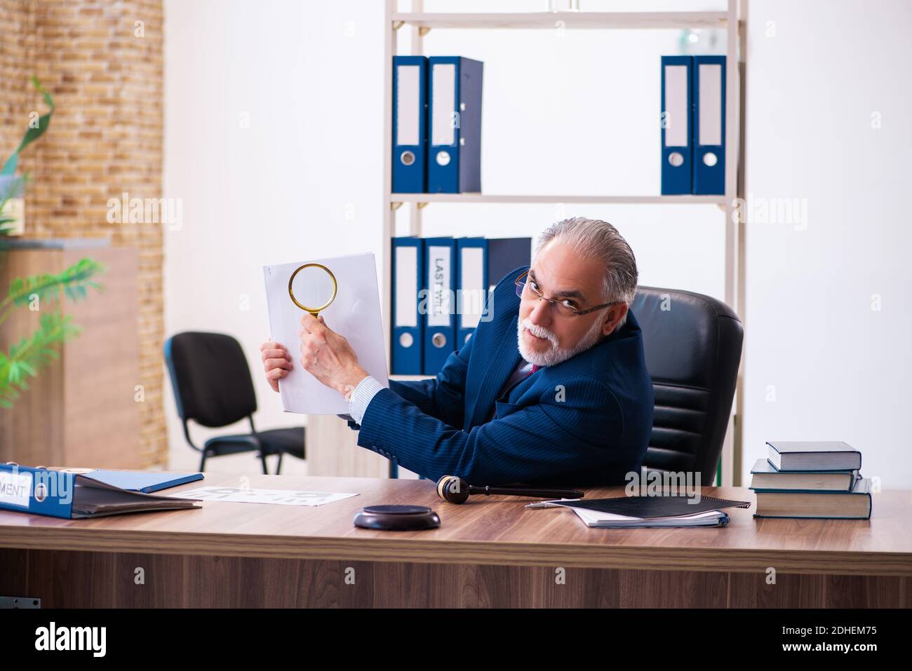 Experienced male judge sitting in the office Stock Photo - Alamy