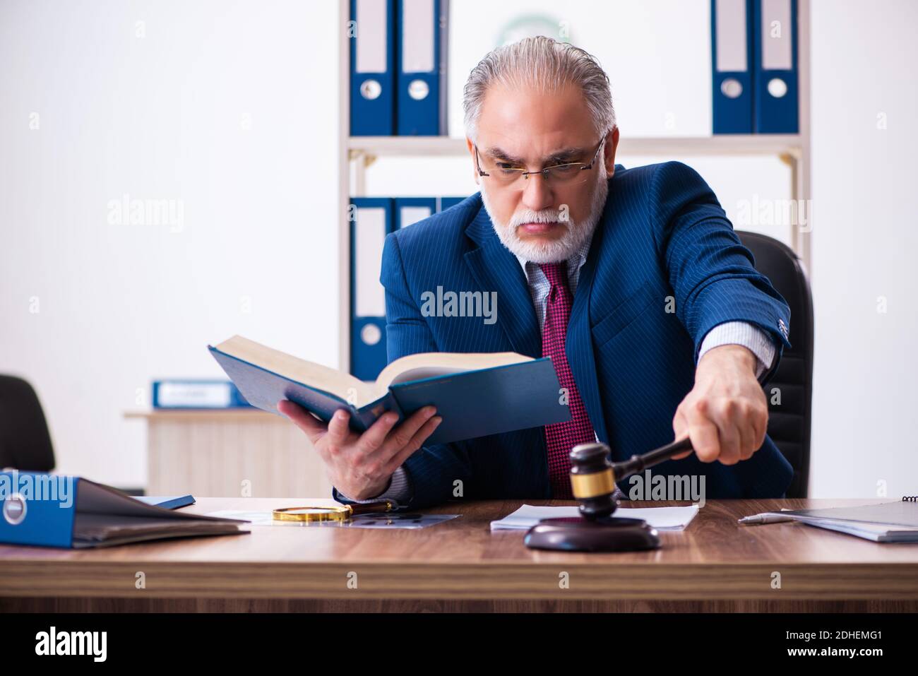 Experienced male judge sitting in the office Stock Photo - Alamy