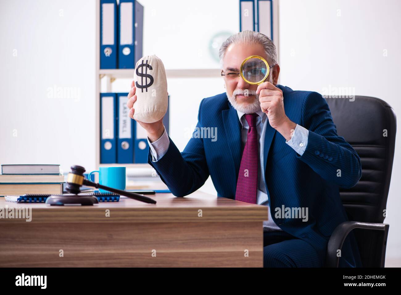 Experienced male judge sitting in the office Stock Photo - Alamy