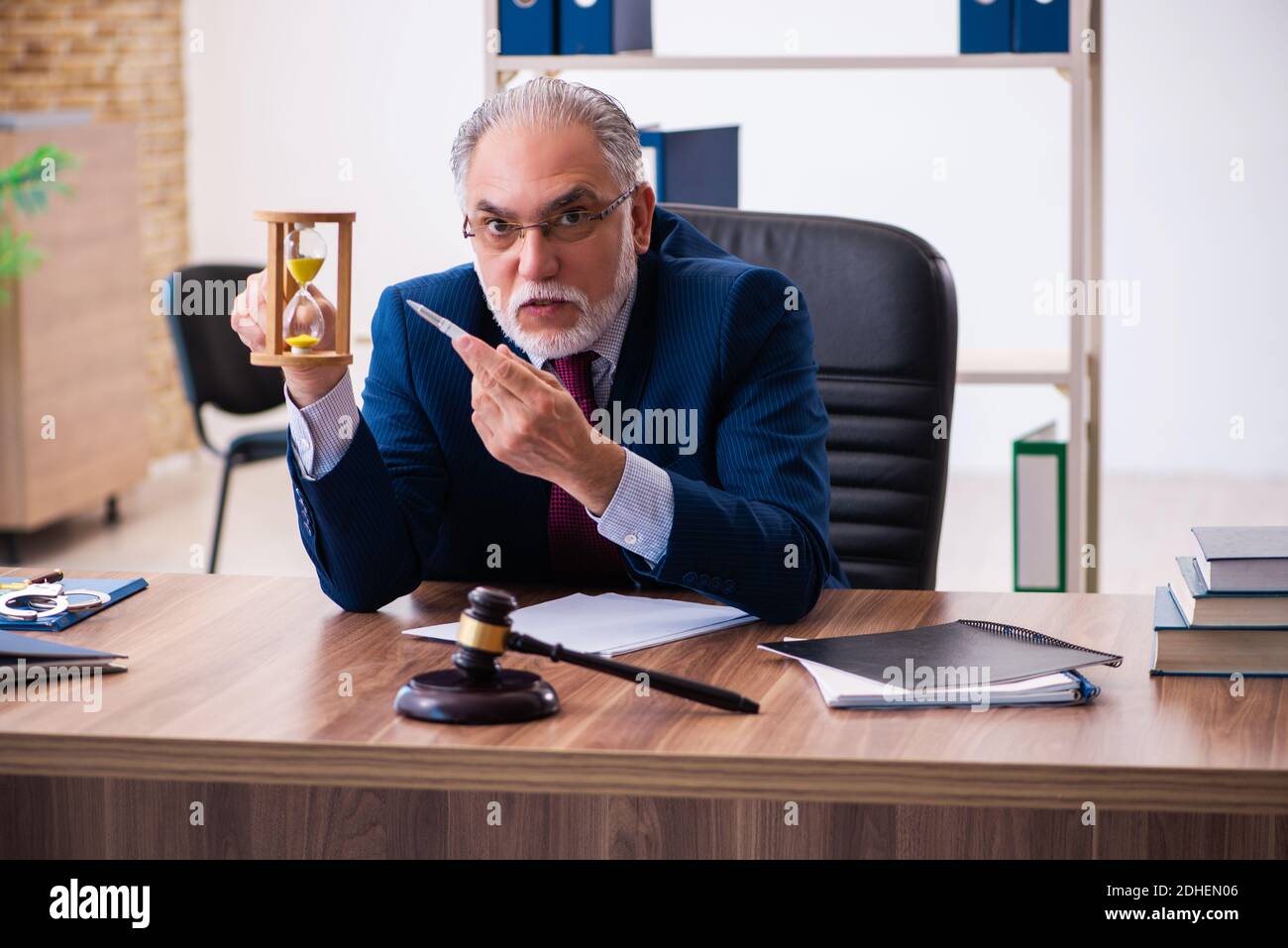 Experienced male judge sitting in the office Stock Photo - Alamy