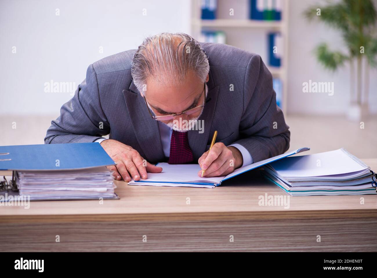 Hardworking employee writing in documents hi-res stock photography and ...