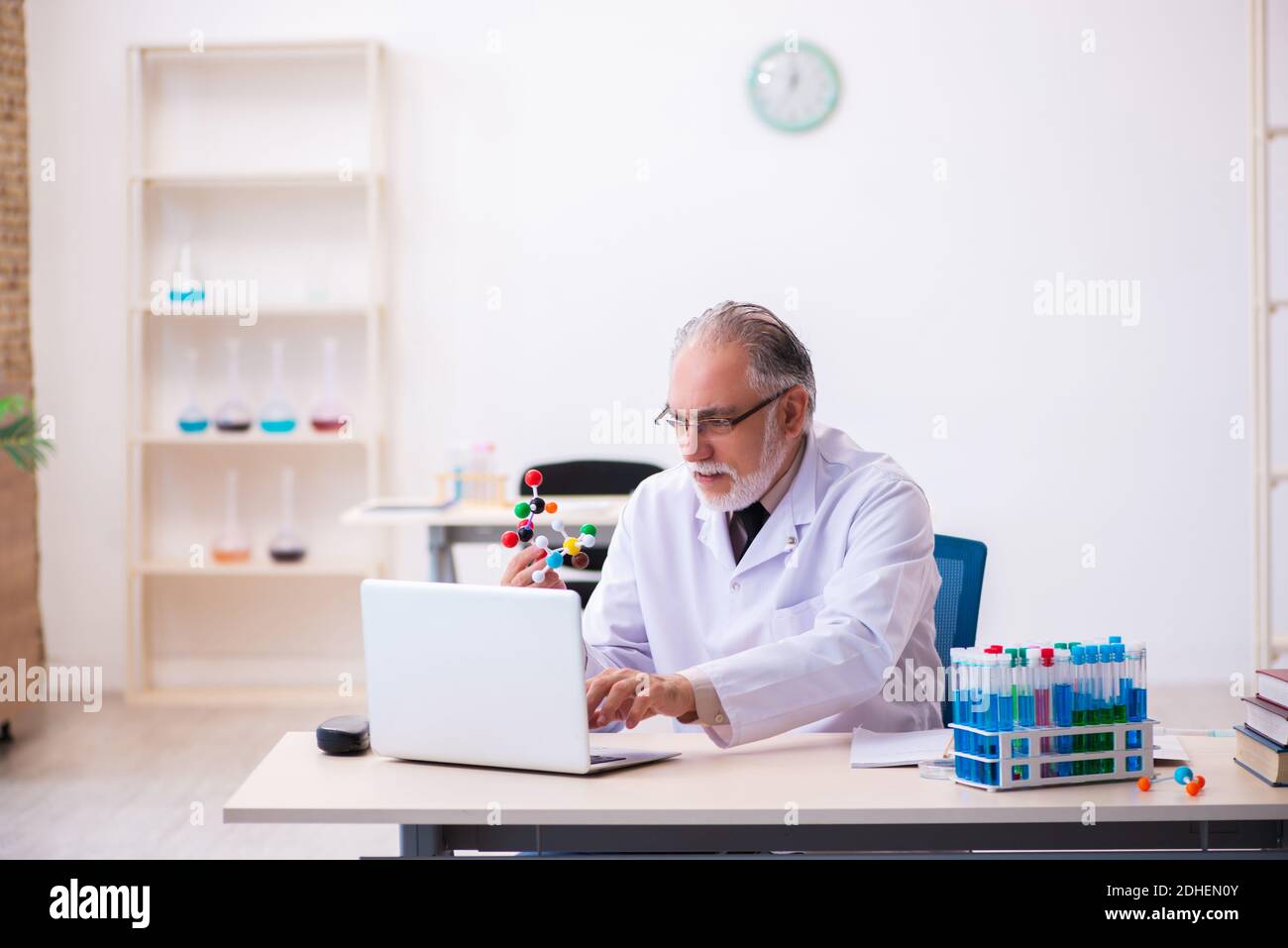 Old male scientist studying molecular model Stock Photo - Alamy