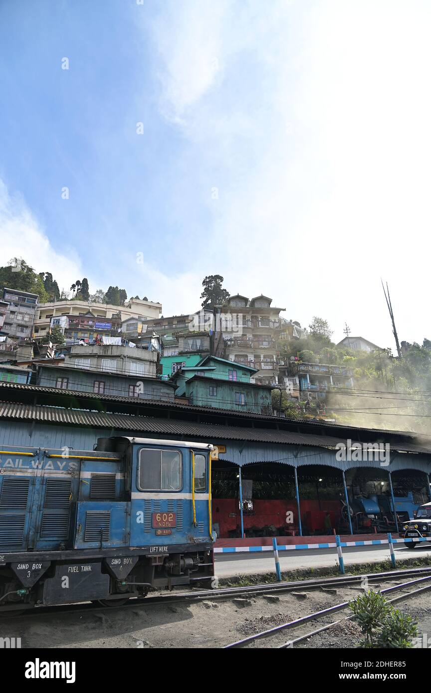 View of DHR diesel locomotive and houses built on the hillside, along ...