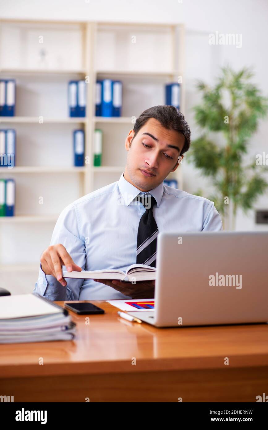 Hardworking young businessman reading documents hi-res stock ...