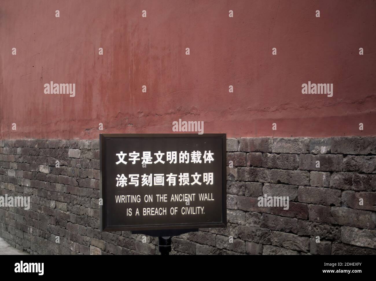 A sign with 'writing on the ancient wall is a breach of civility' on in ...