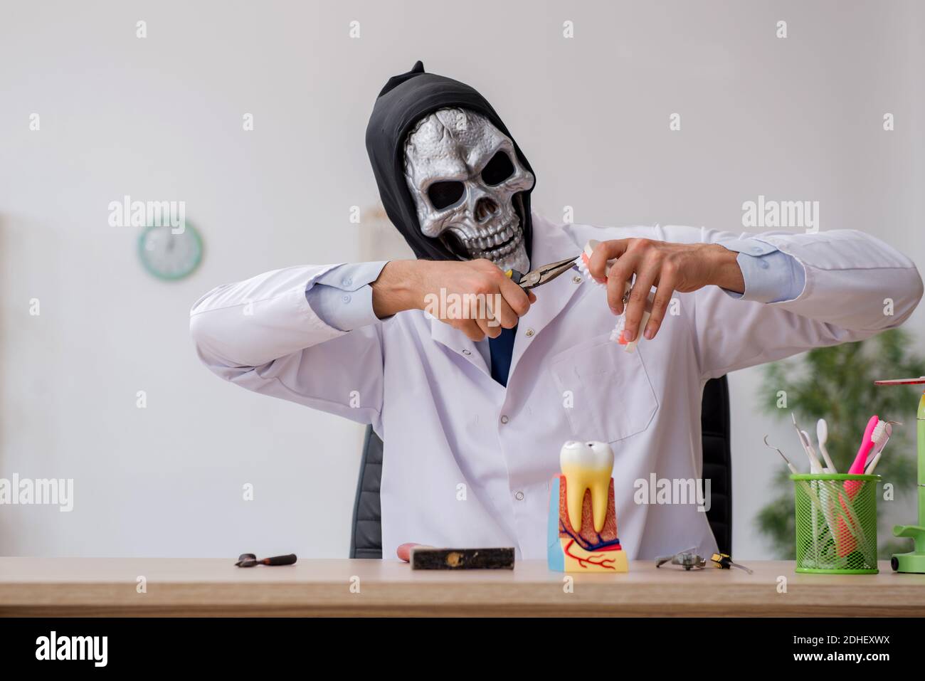 Devil doctor stomatologist working in the clinic Stock Photo - Alamy
