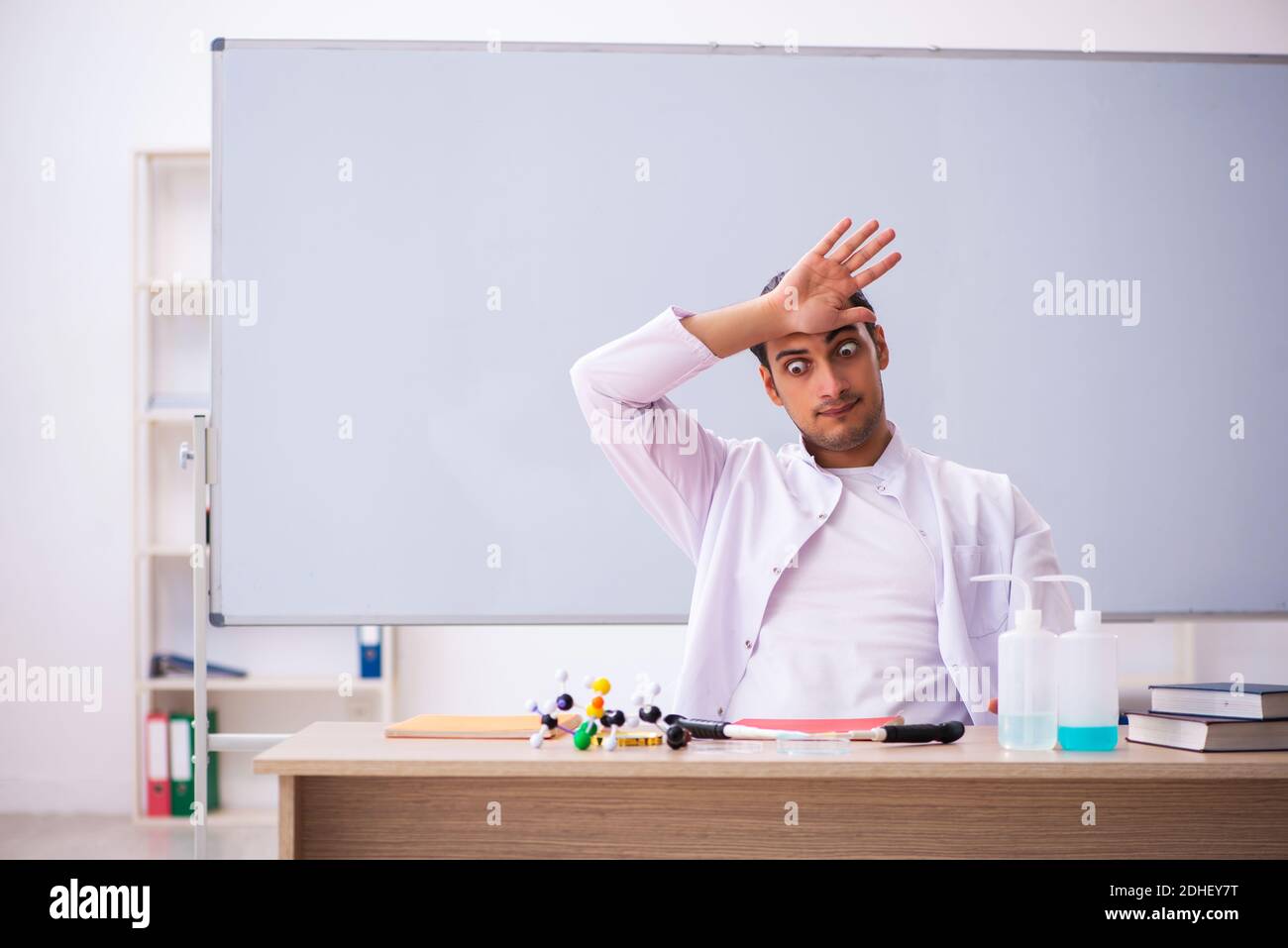 Young male chemistry teacher in the classroom Stock Photo - Alamy