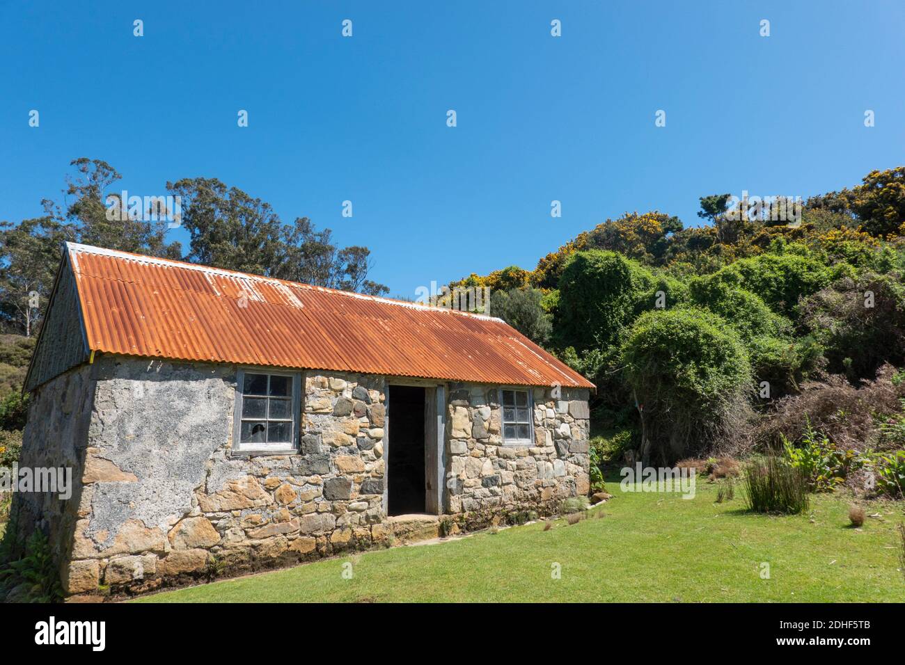 Old stone cottage with rusty corrugated iron roof Stock Photo - Alamy