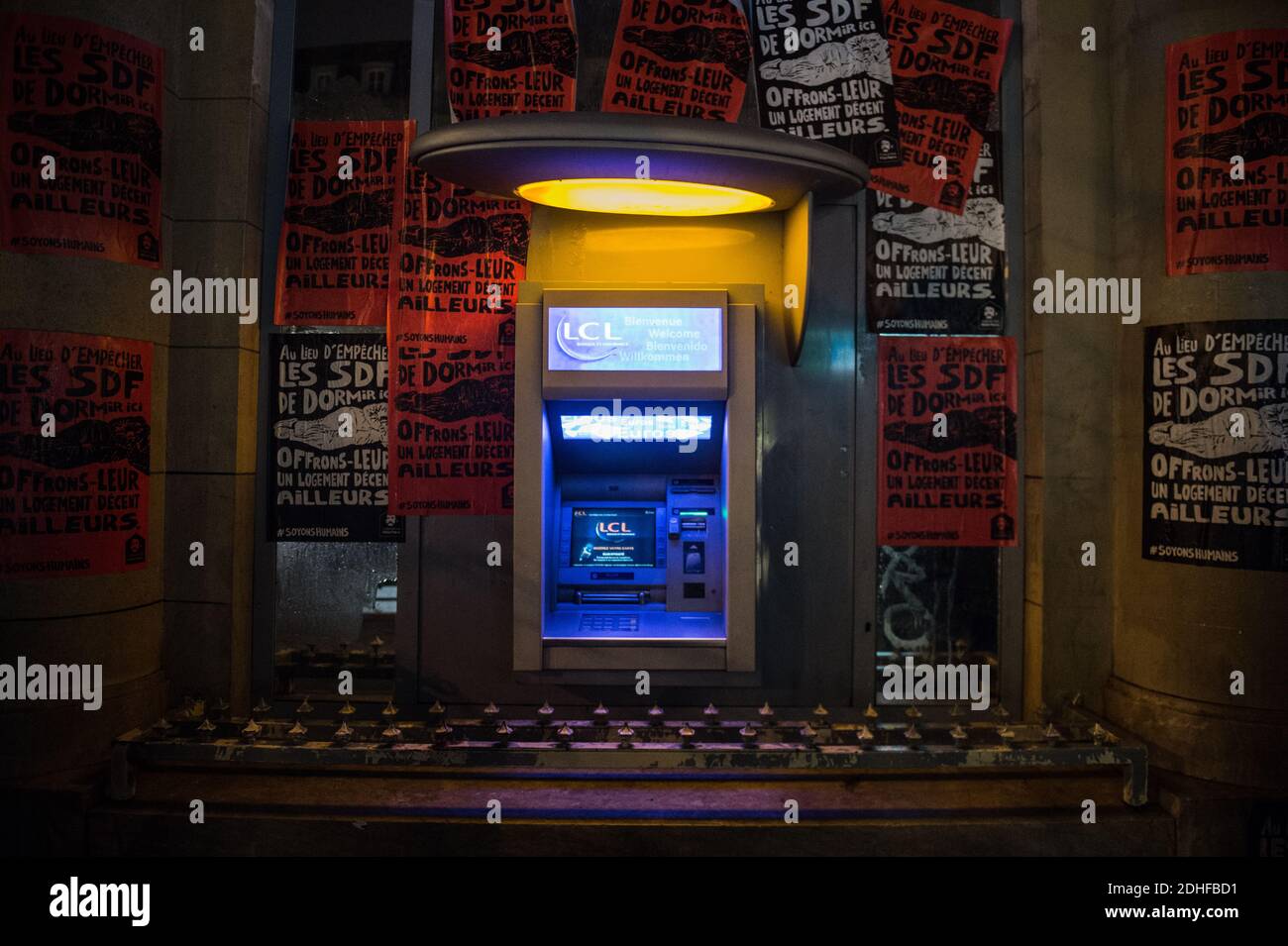 Activists from the Fondation Abbe Pierre foundation stick leaflets and ...