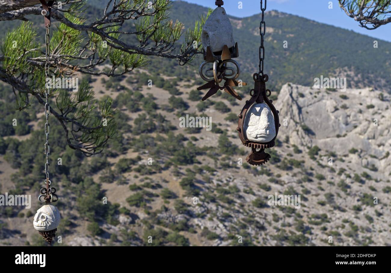 Three stone idol on the branches of pine tree in the Crimean mountains Stock Photo - Alamy