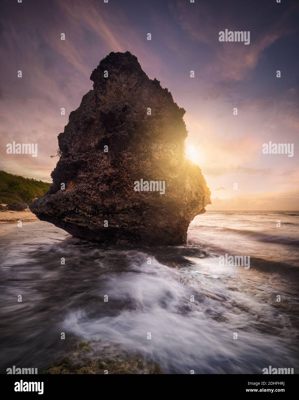 A rock in a sea on background of the sunset sky - perfect for ...