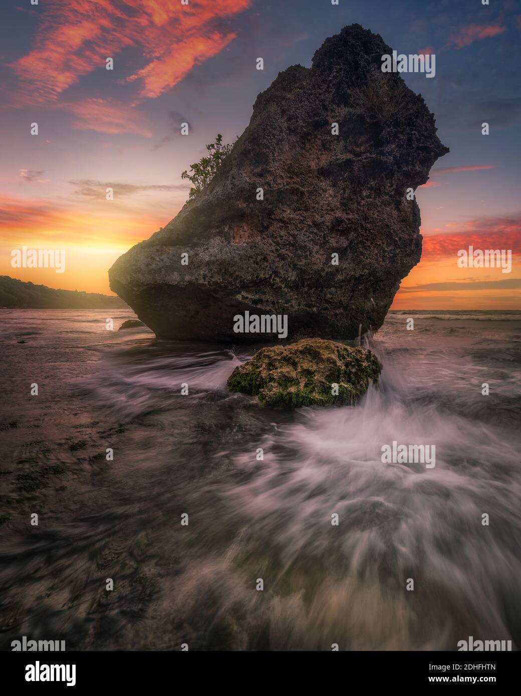 A rock in a sea on background of the sunset sky - perfect for ...