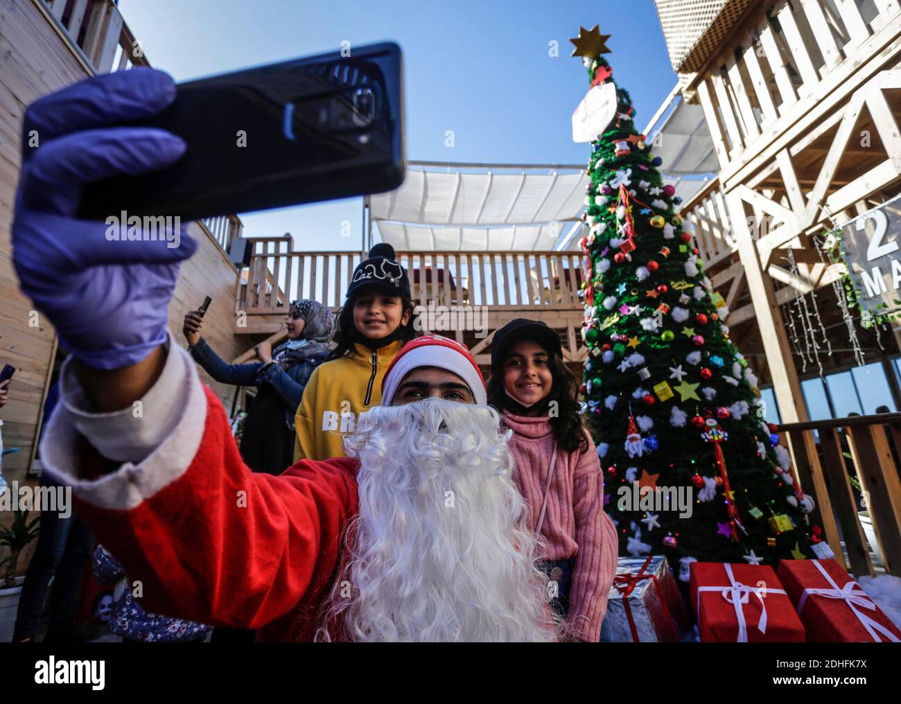 Gaza, Palestine. 10th Dec, 2020. A Palestinian waiter dressed as Santa ...