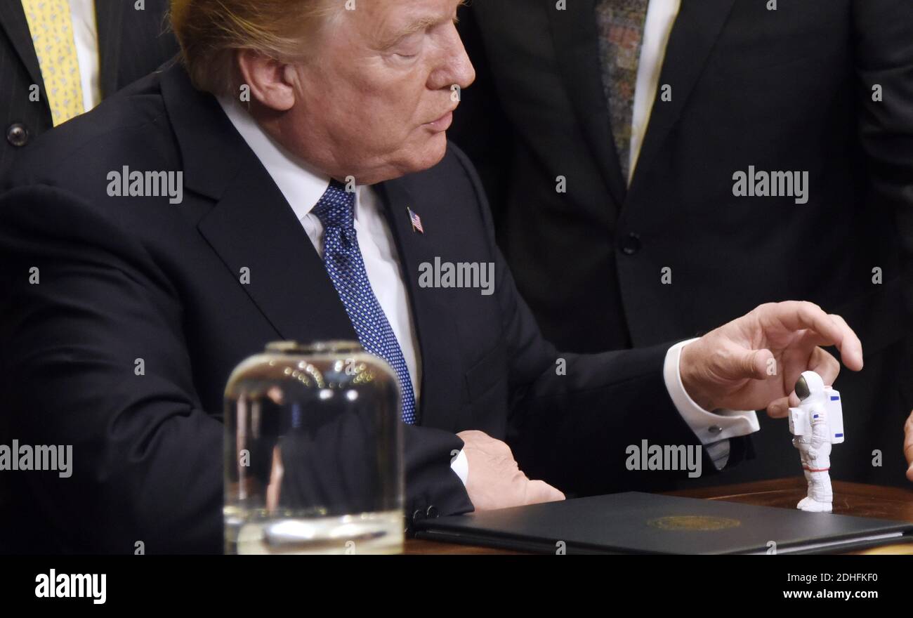 U.S. President Donald Trump holds an astronaut figure given by Apollo ...