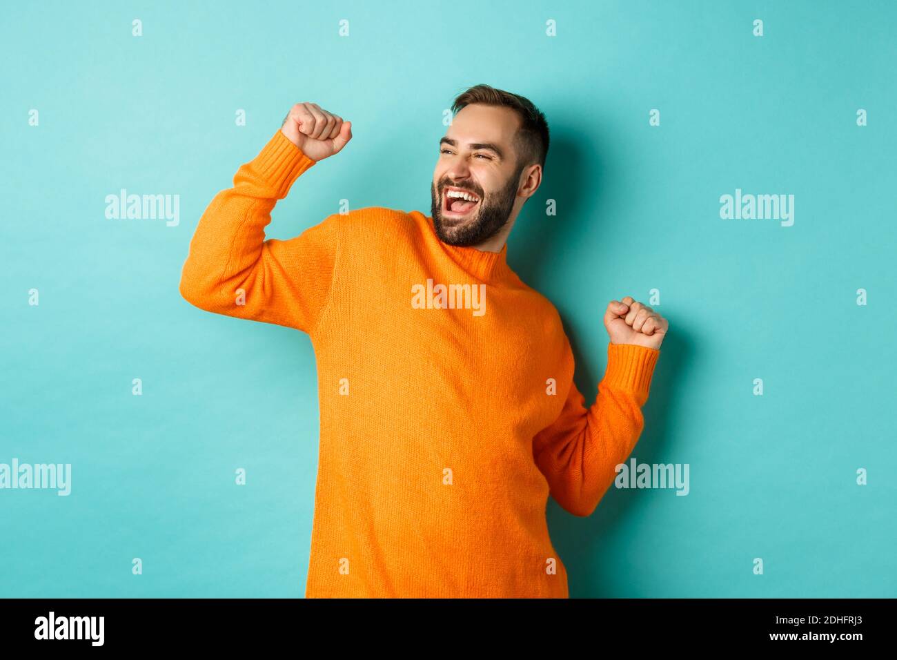 Happy man raising arm, feeling like winner, triumphing and celebrating ...