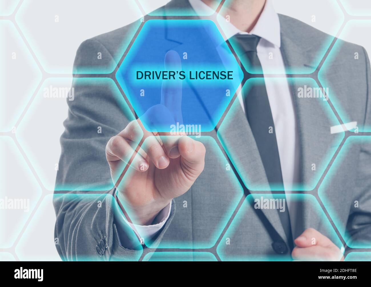 Young businessman touching text DRIVER'S LICENSE on virtual screen ...