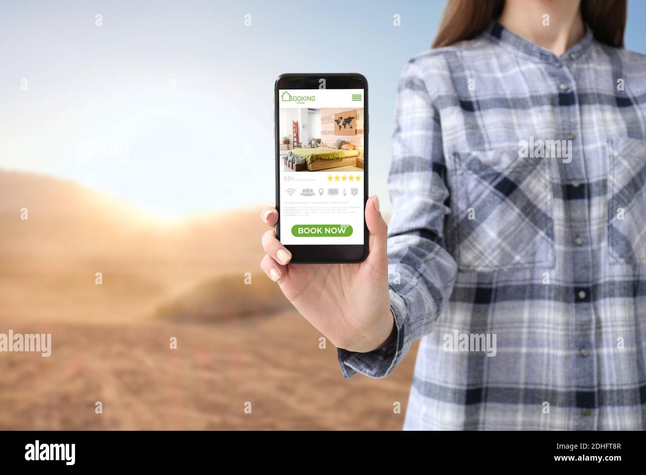 Young woman with mobile phone booking room in hotel online Stock Photo ...