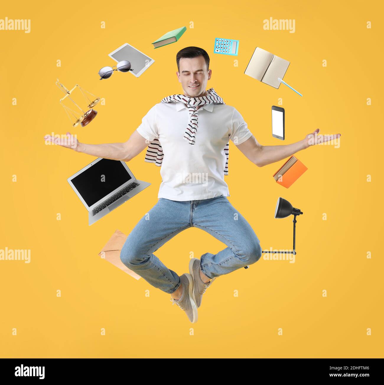 Different things flying around handsome meditating man on color ...