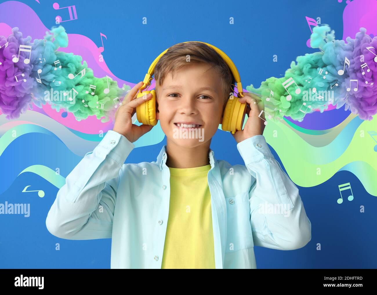 Little boy listening to music on color background Stock Photo - Alamy