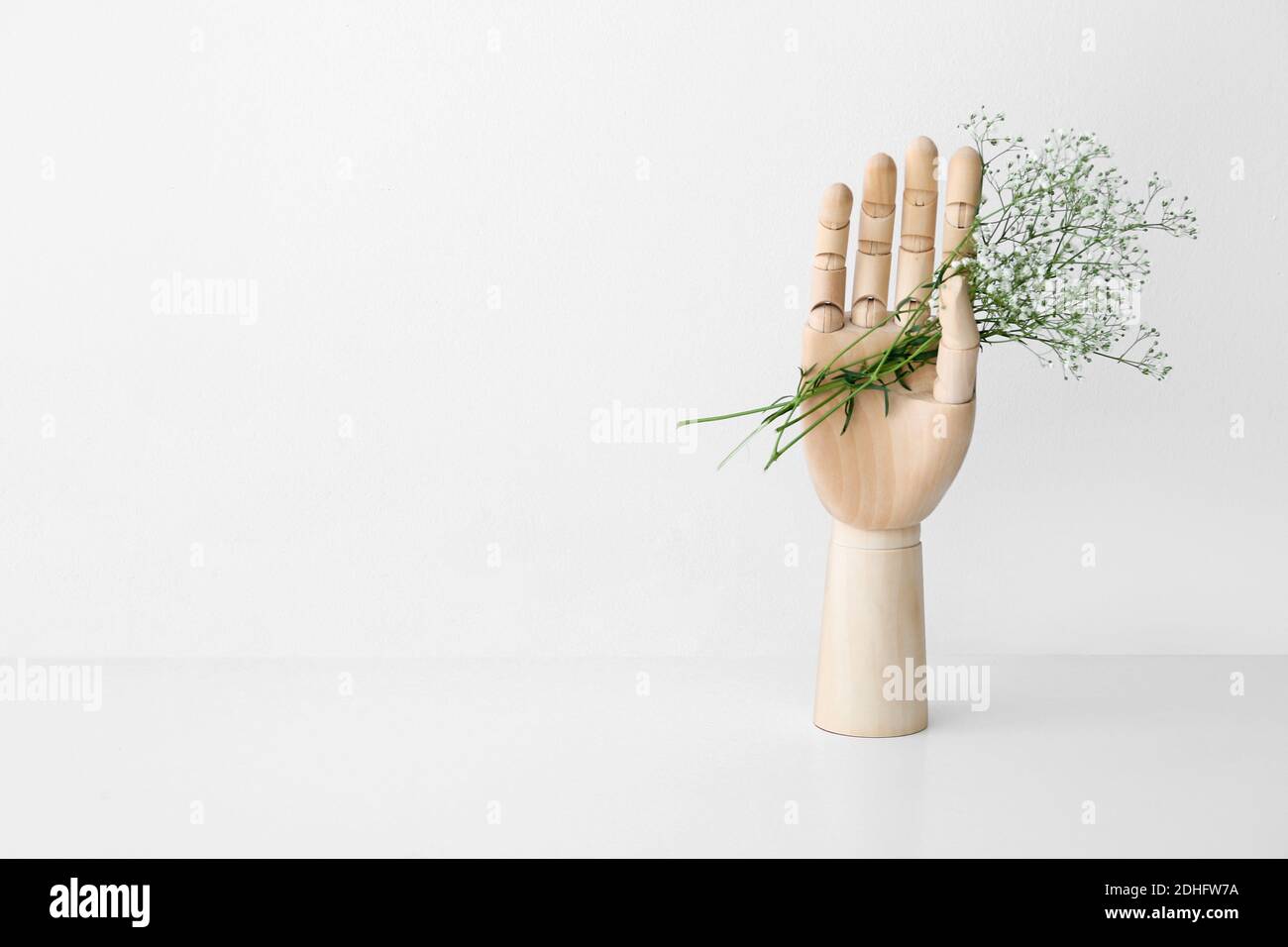 Wooden hand with flowers on white background Stock Photo - Alamy
