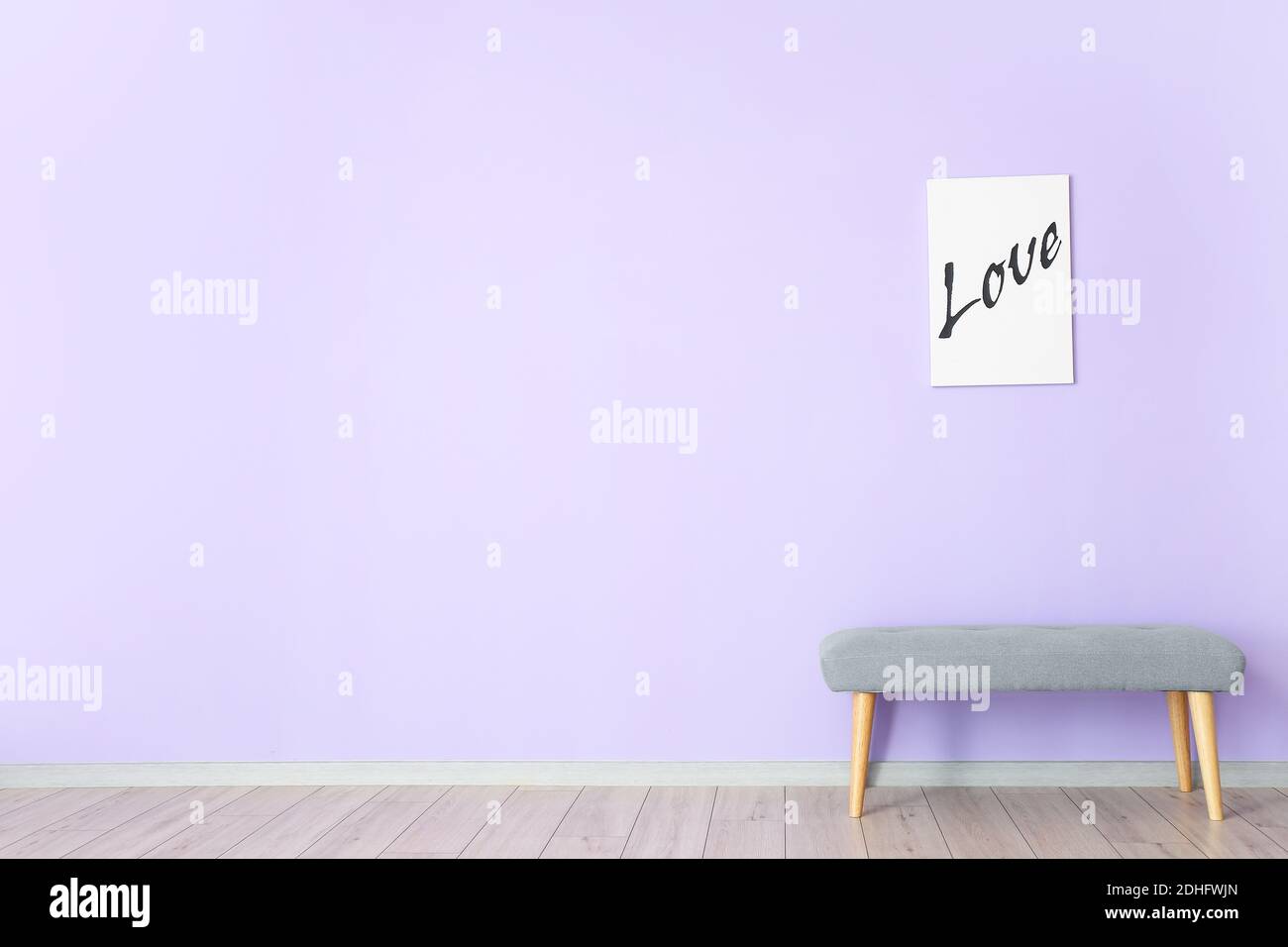 Cozy bench and picture near color wall in room Stock Photo - Alamy