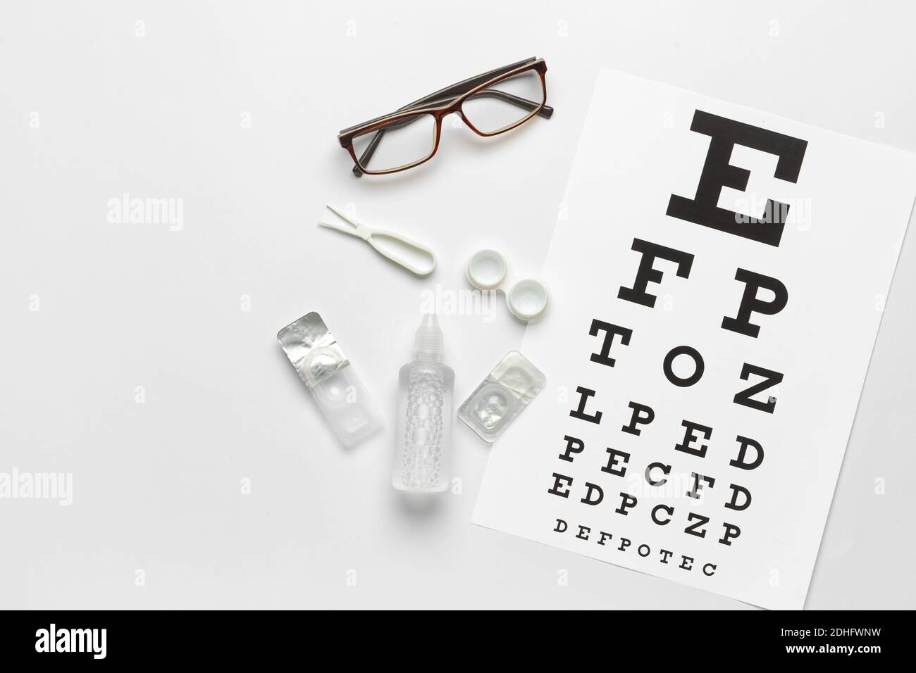 Container with contact lenses, solution, tweezers, eyeglasses and eye ...