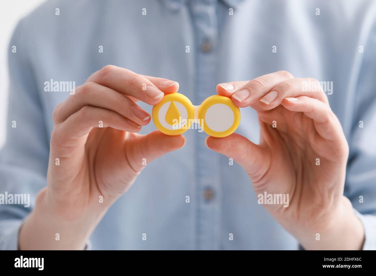 Woman holding contact lens case Stock Photo - Alamy
