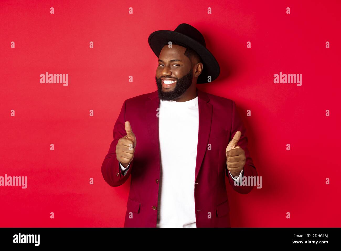 Cheerful Black man having fun on party, showing thumbs up in approval ...