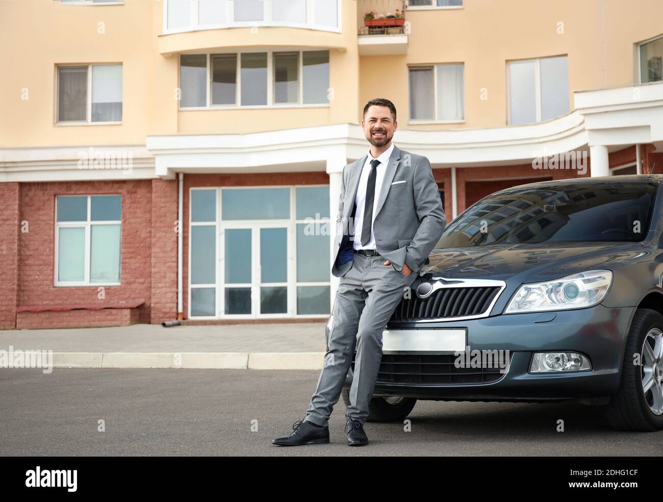 Successful businessman near modern car Stock Photo - Alamy