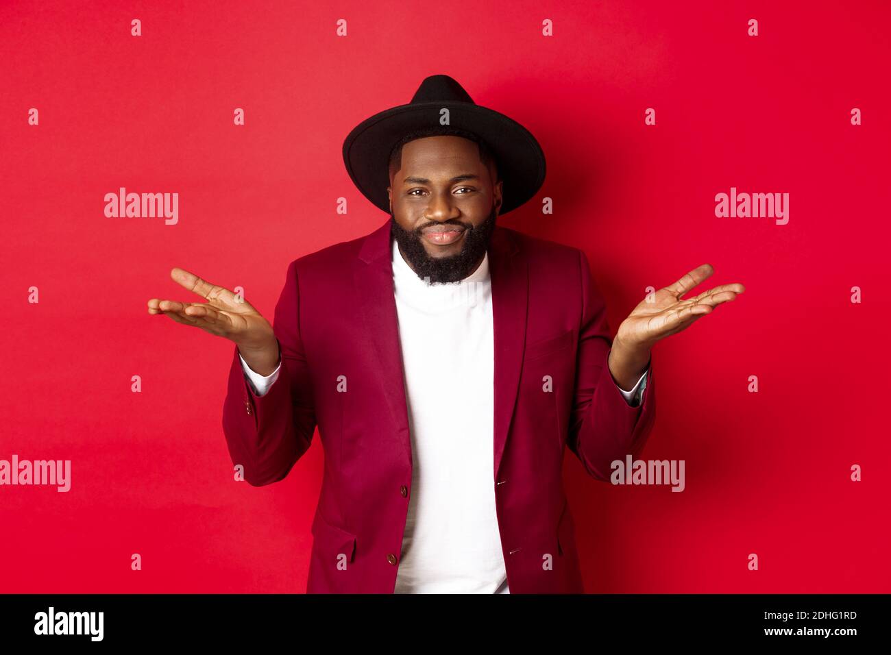 Clueless and unbothered Black man shrugging with indifferent look, dont ...