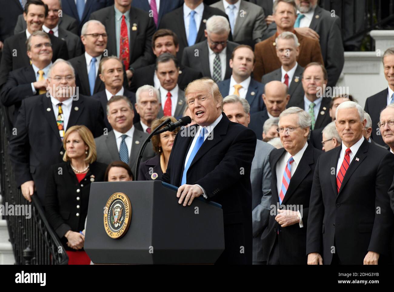 President Donald Trump celebrates the tax bill passage with members of ...