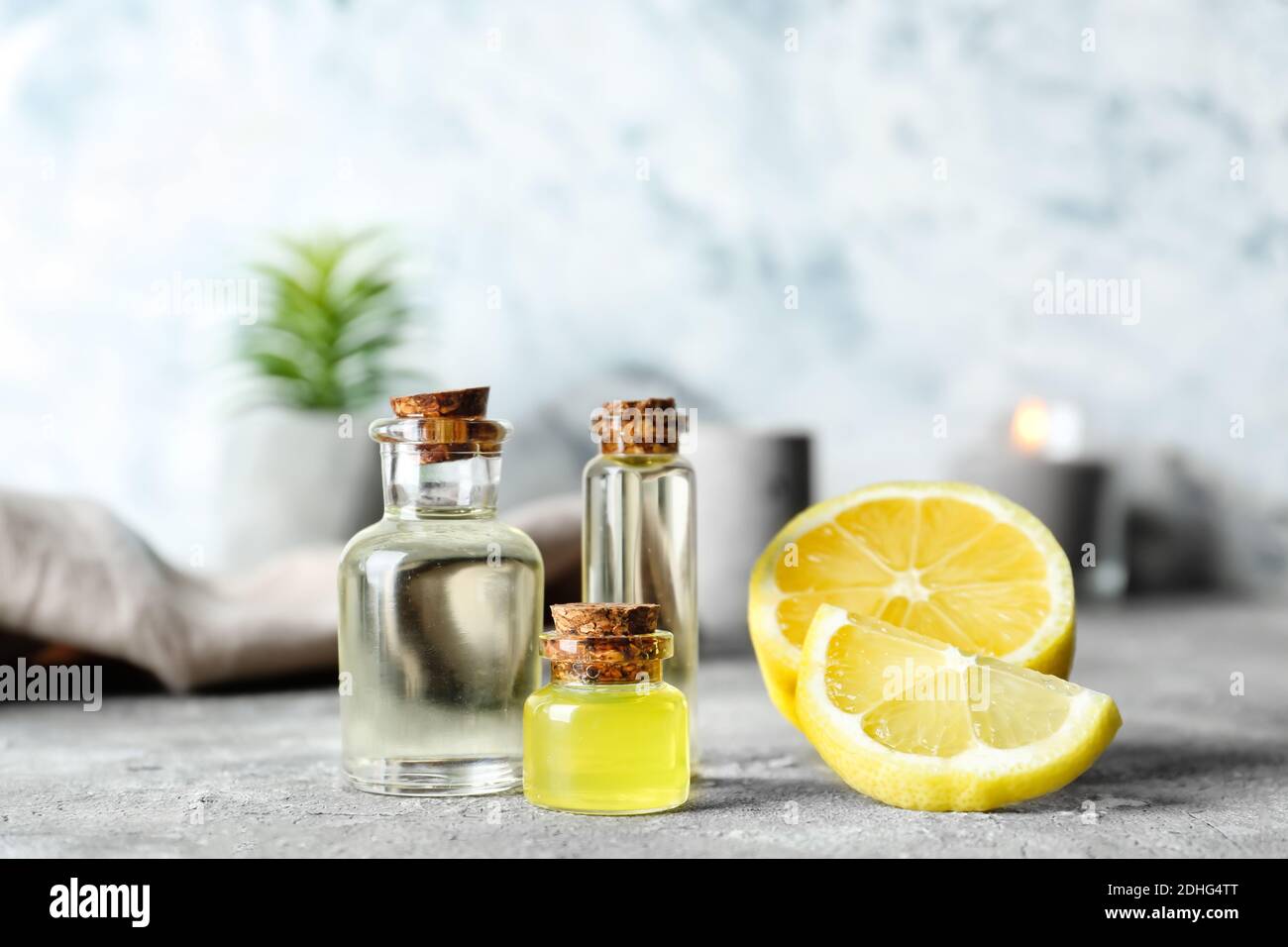 Bottles of lemon essential oil on table Stock Photo - Alamy