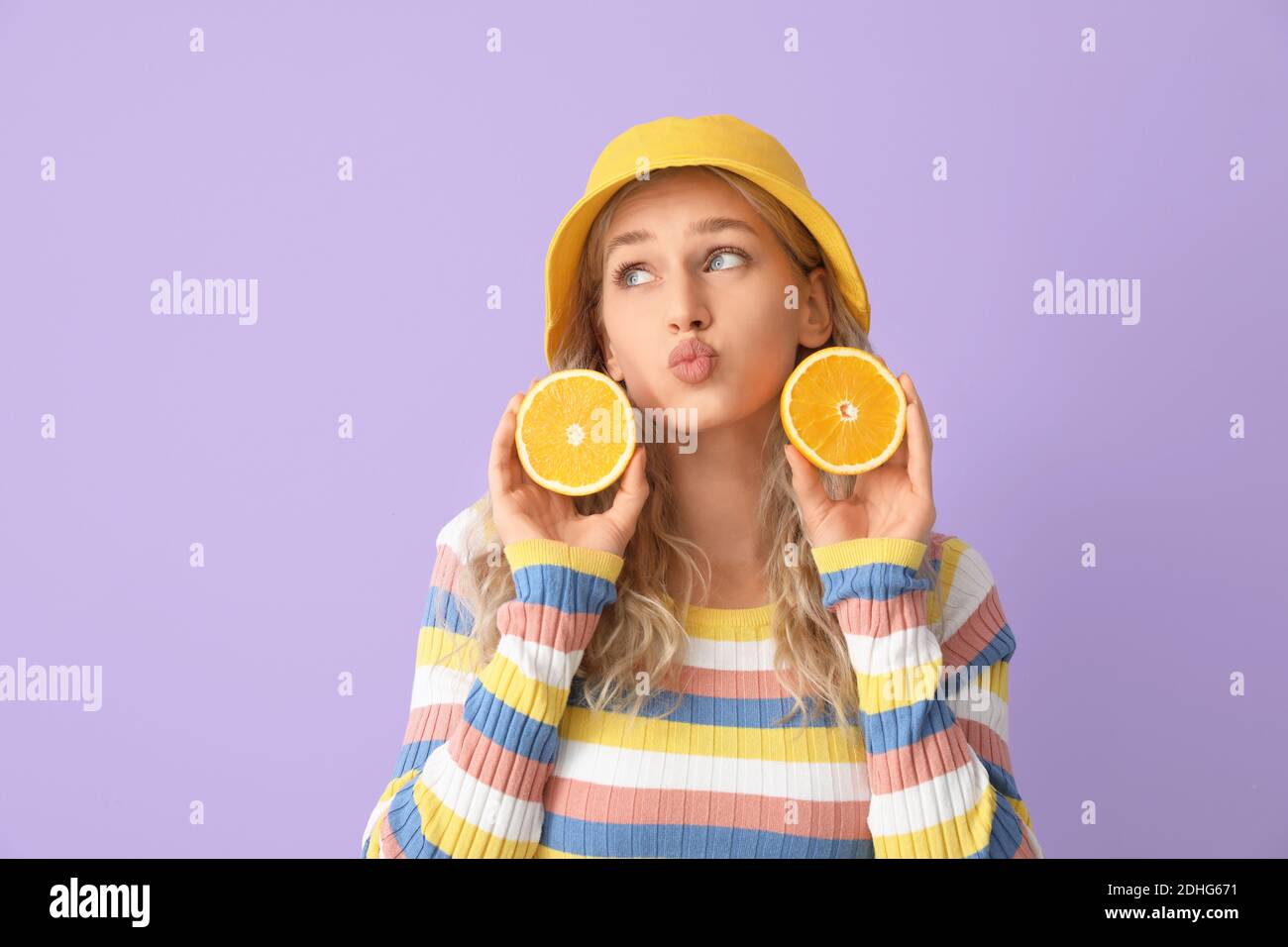 Beautiful young woman with cut orange on color background Stock Photo ...