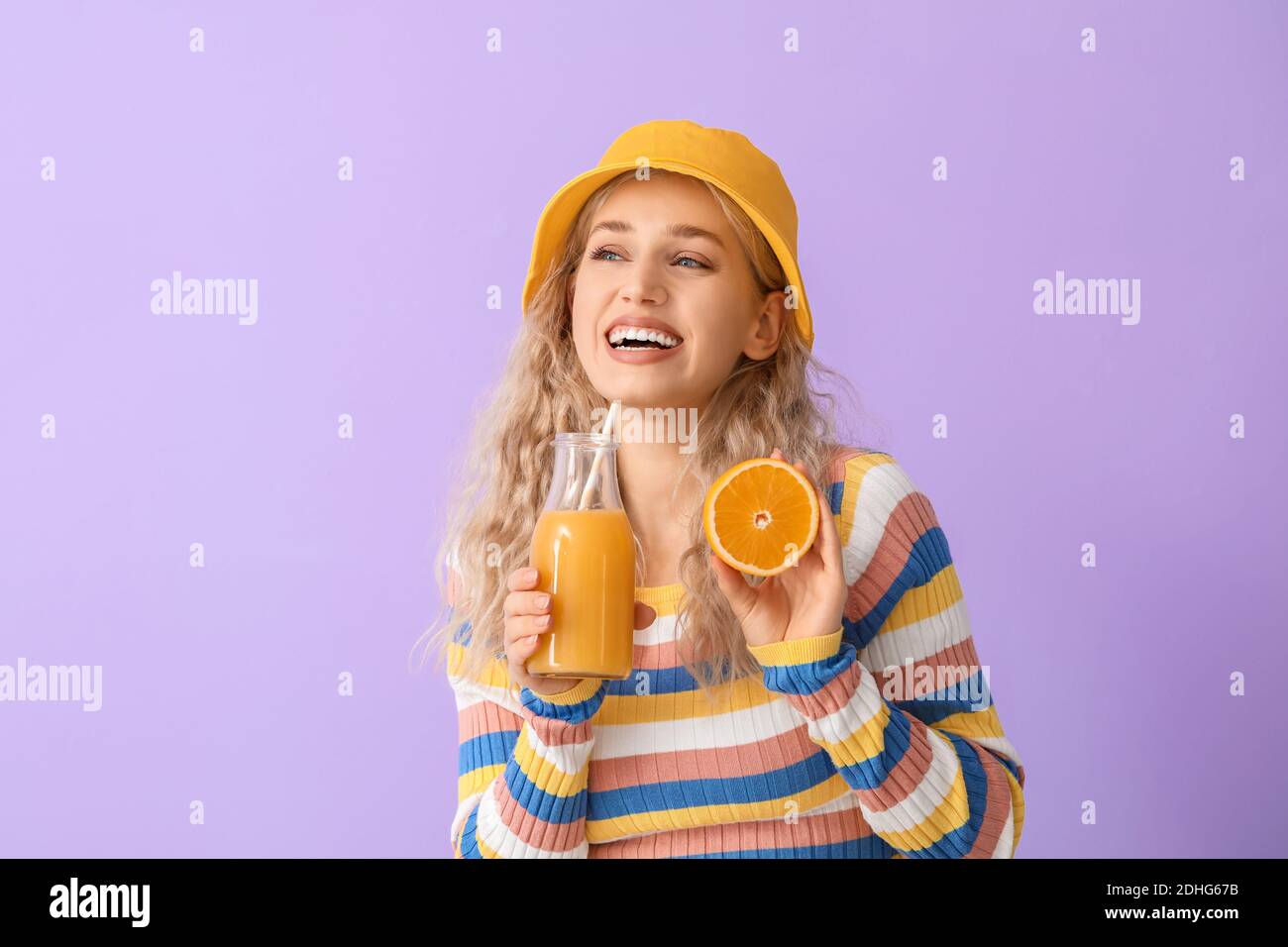 Beautiful young woman with orange juice on color background Stock Photo ...
