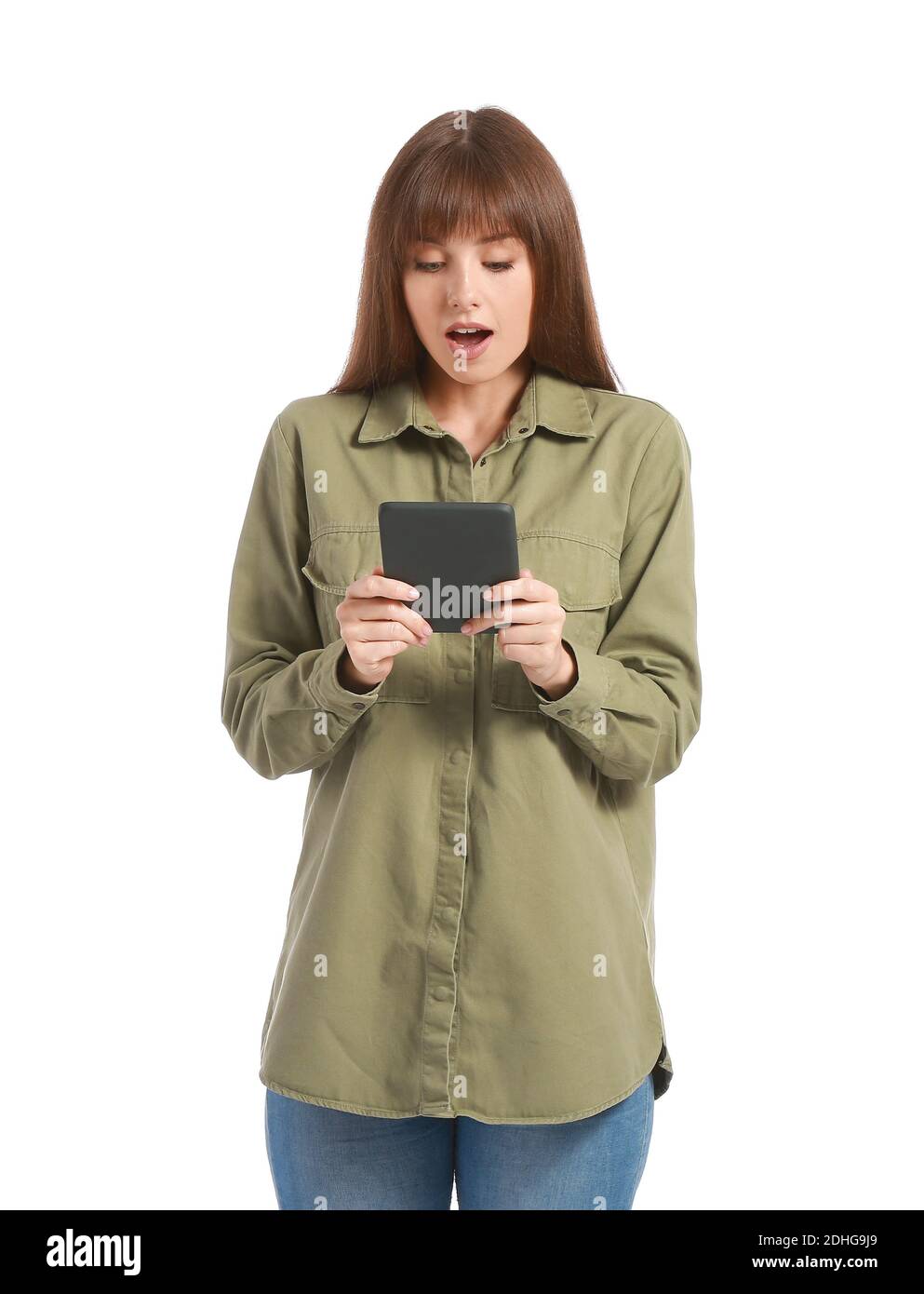 Surprised young woman with e-reader on white background Stock Photo - Alamy