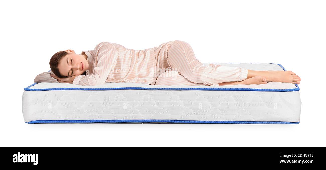 Young woman sleeping on mattress against white background Stock Photo ...