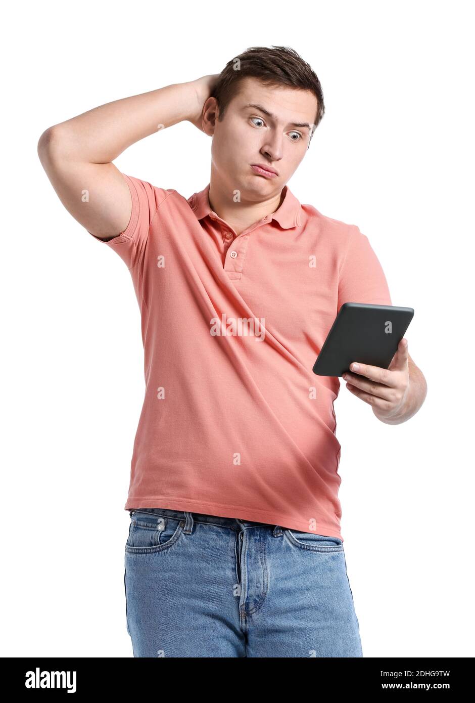 Shocked young man with e-reader on white background Stock Photo - Alamy