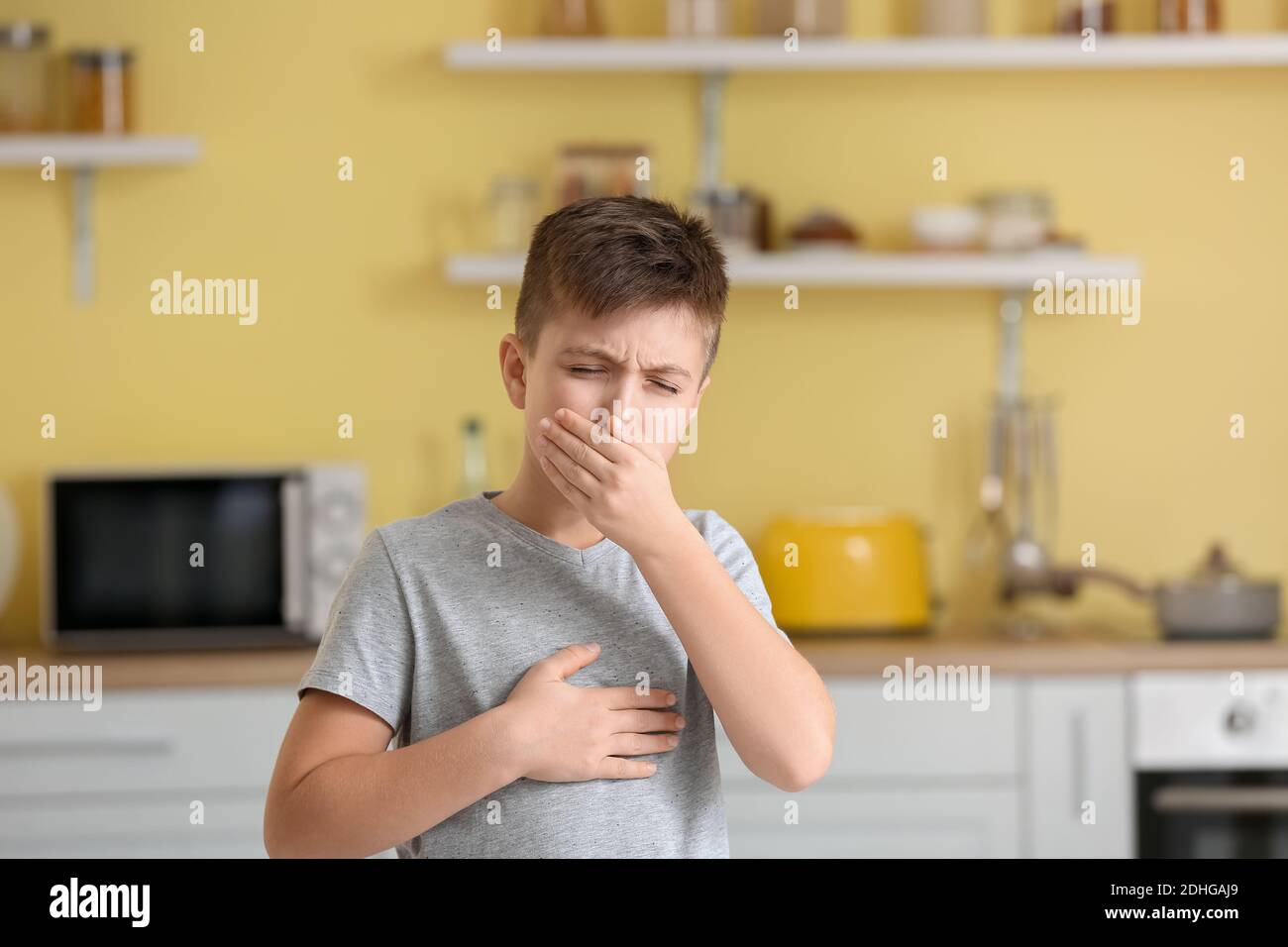 Coughing little boy at home Stock Photo - Alamy
