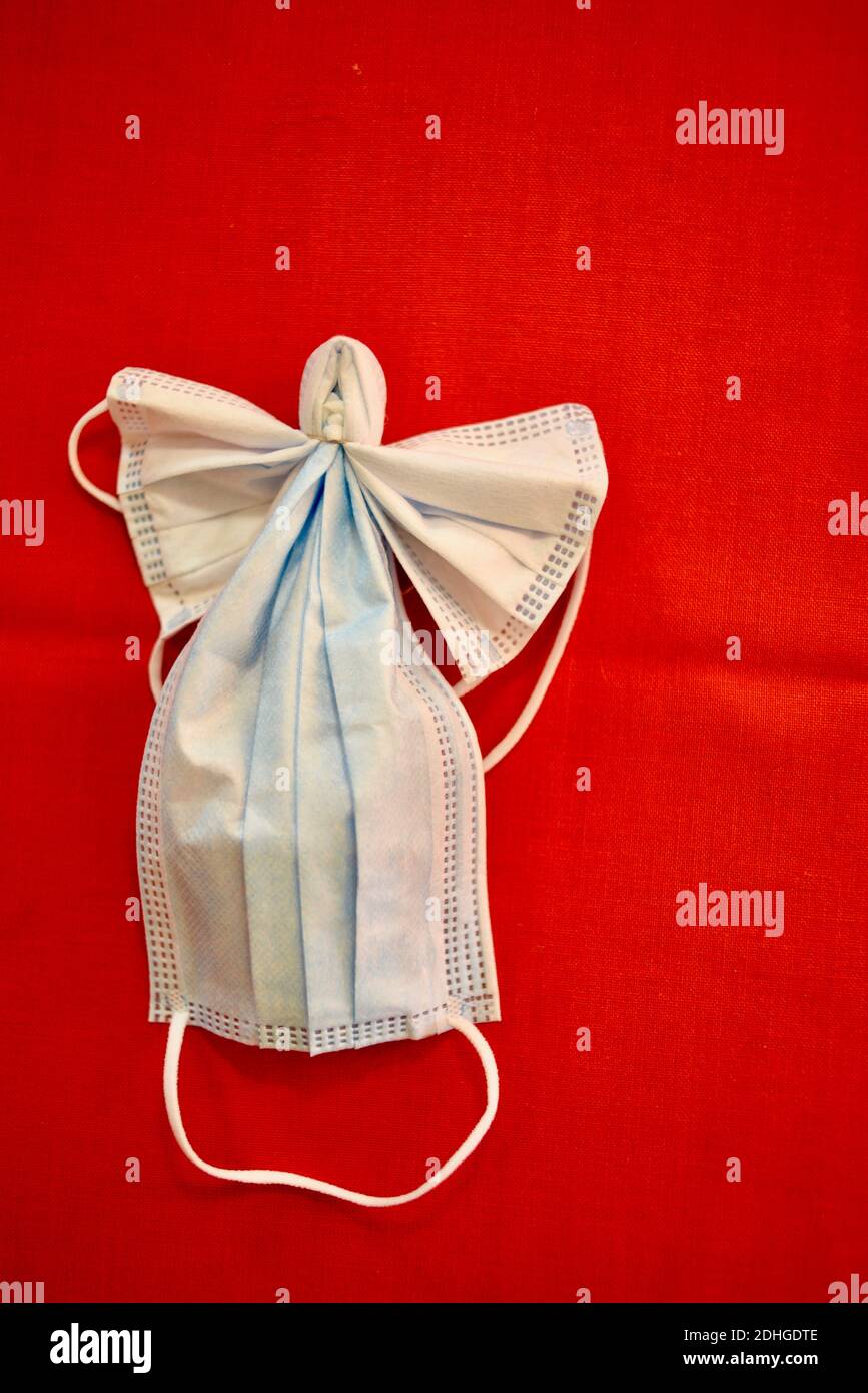 Two surgical masks formed into the crafty shape of an angel with wings ...