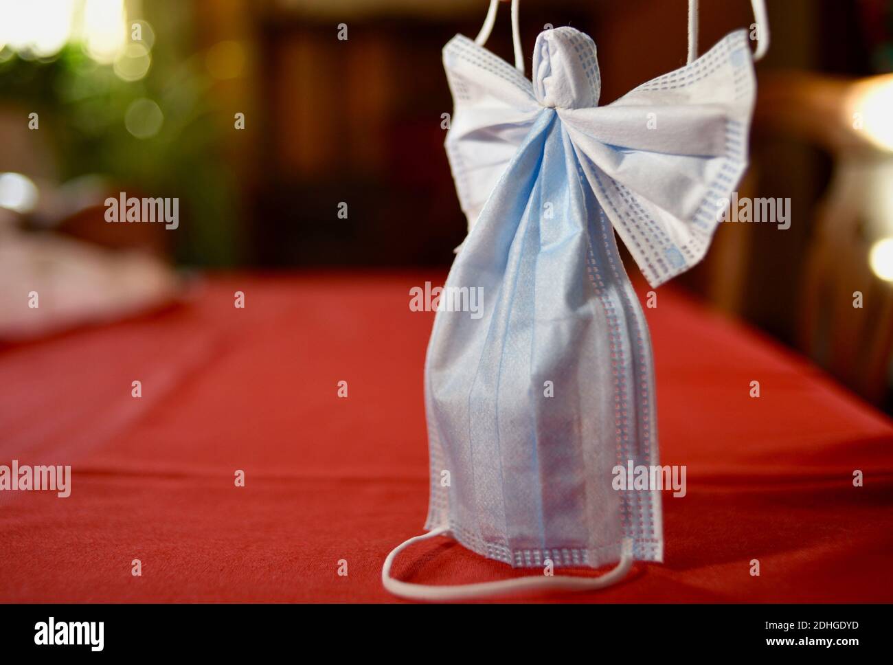 Two surgical masks formed into the crafty shape of an angel with wings ...