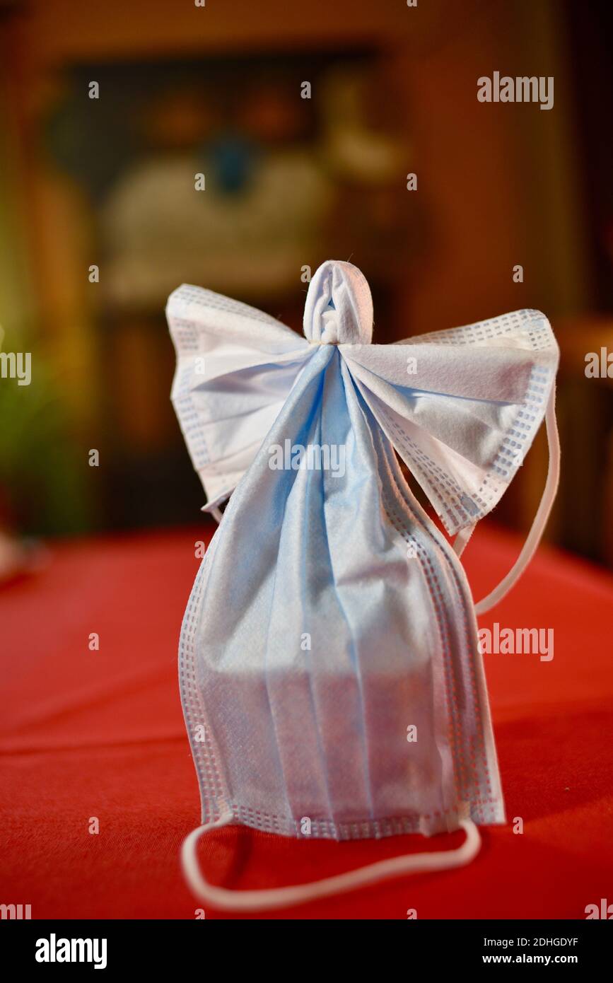 Two surgical masks formed into the crafty shape of an angel with wings ...