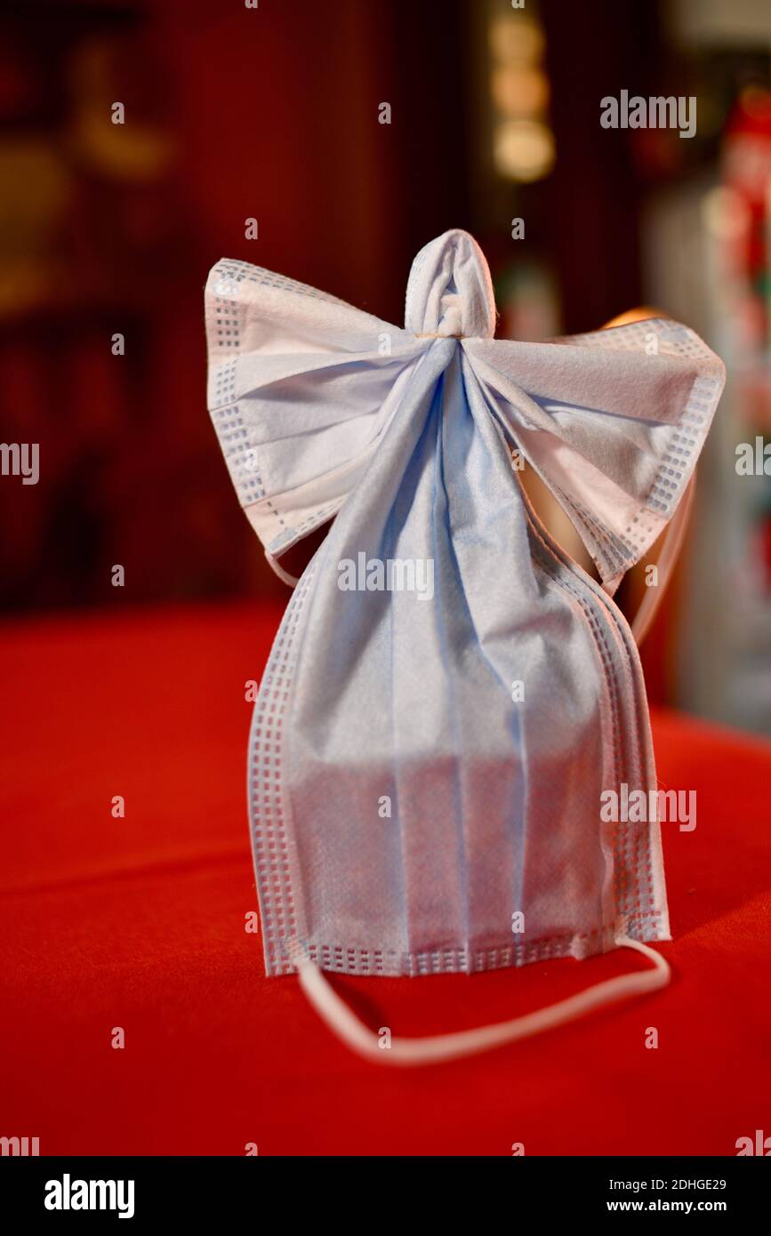 Two surgical masks formed into the crafty shape of an angel with wings ...