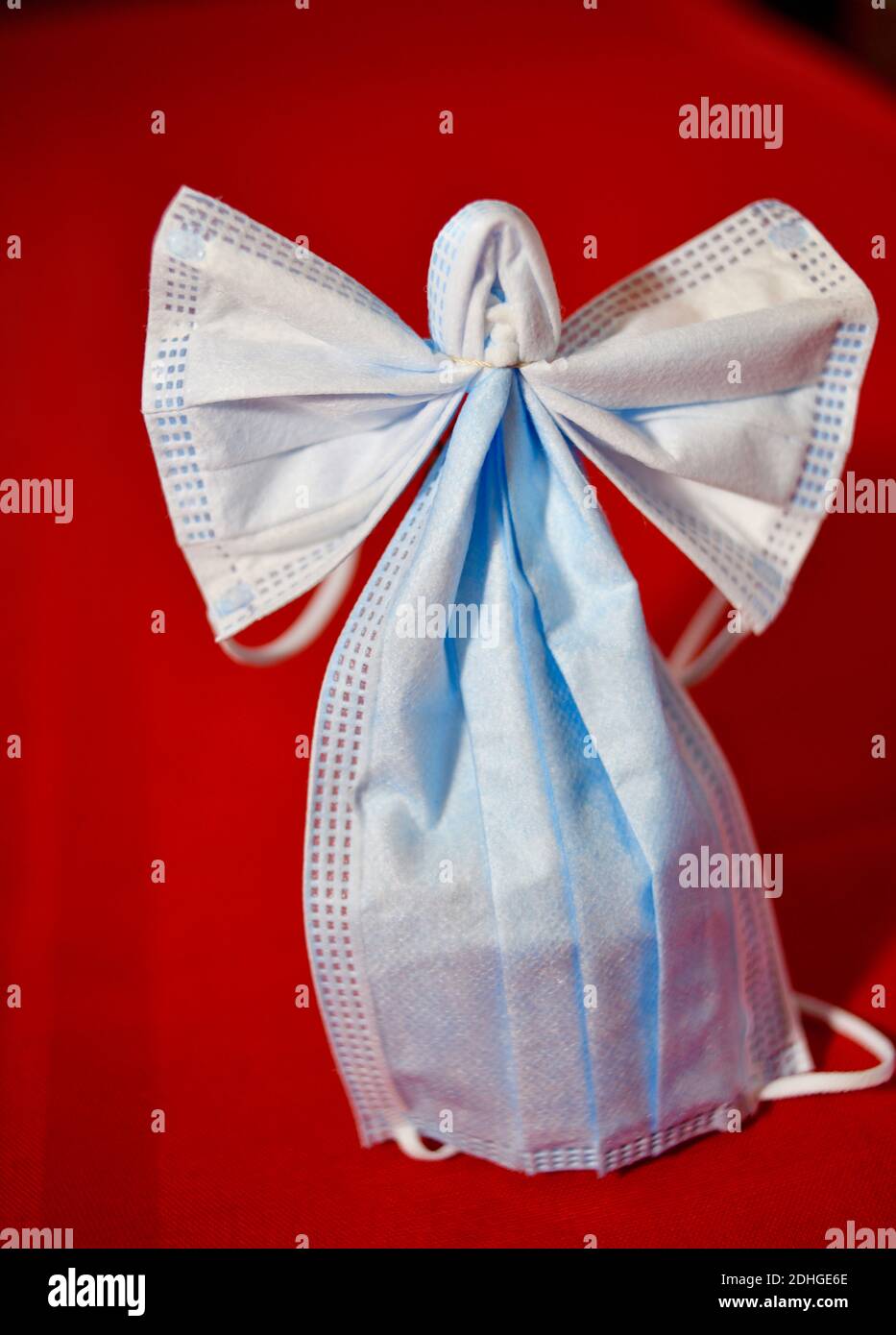 Two surgical masks formed into the crafty shape of an angel with wings ...